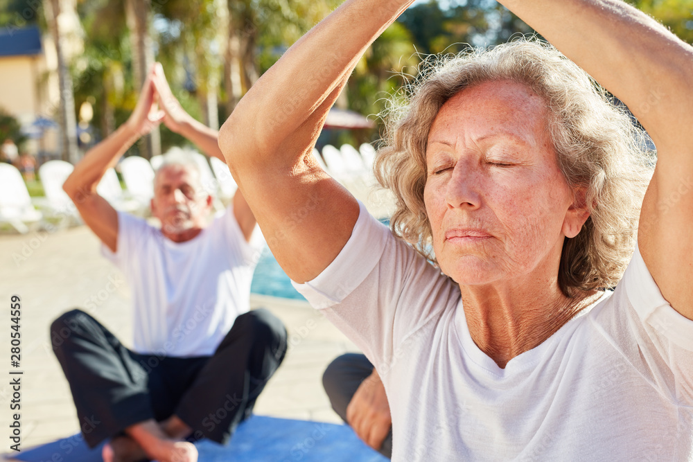 Old woman sits and meditates in the spa by the pool Stock Photo | Adobe ...
