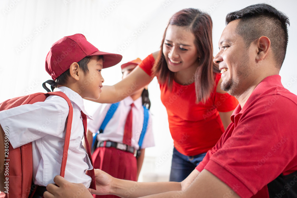 parent help their children getting ready for school. back to school ...