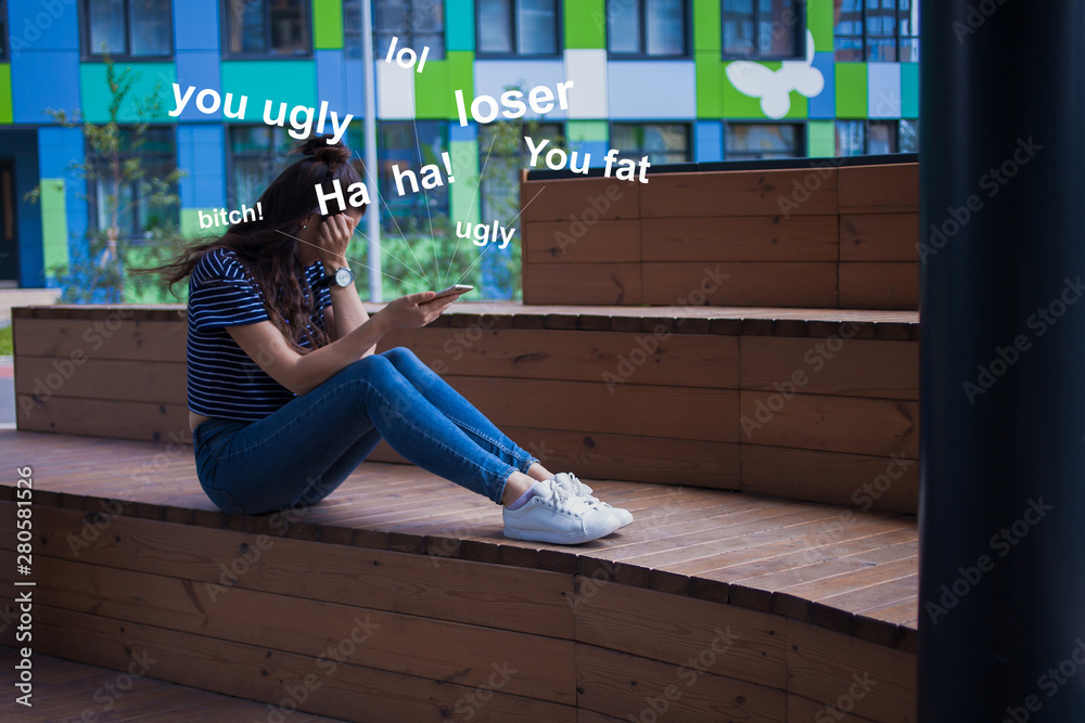 Young girl with long hair, with a phone, crying, covering face with ...