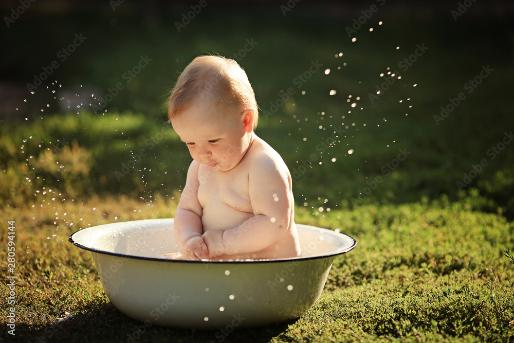 Little girl bathes in a basin Stock Photo | Adobe Stock