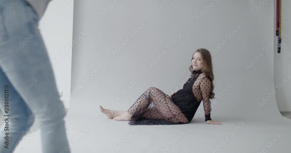 Backstage of the photo shoot: Beautiful caucasian pregnant model sits ...