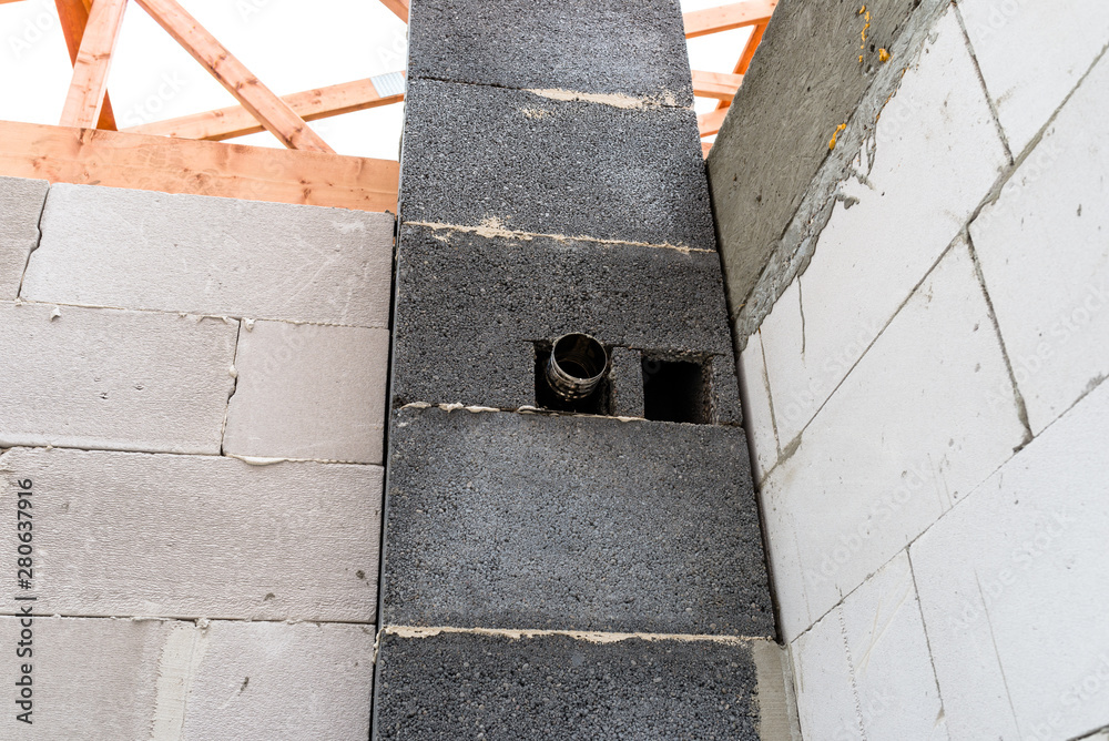 System chimney on a detached house under construction, visible chimney ...