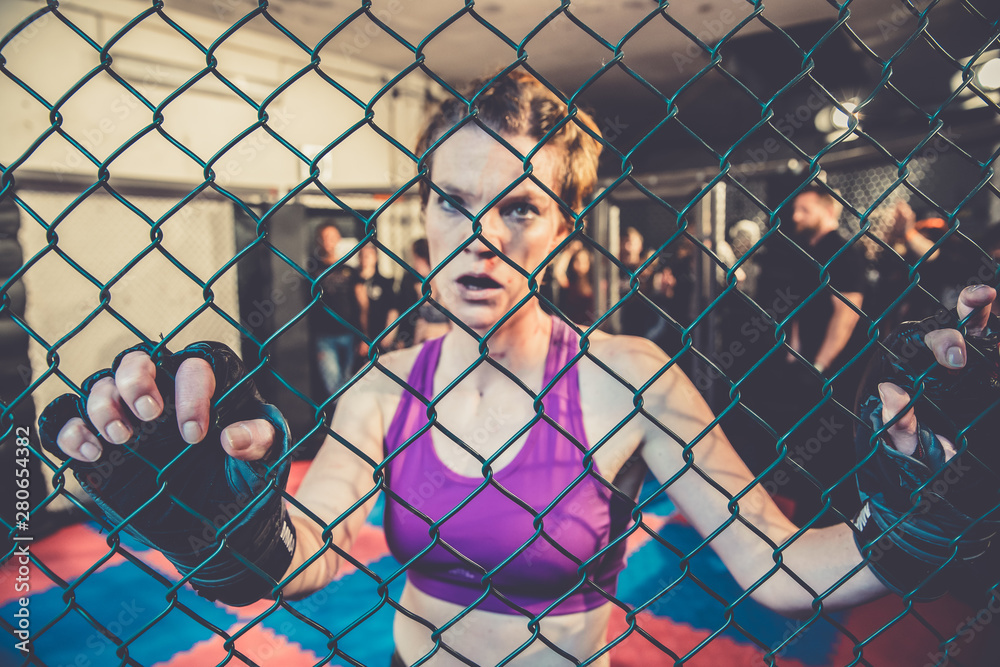 Gorgeous woman, mma fighter in gym during training. Preparing for a ...