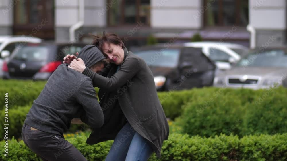 Failed attempt of thief grabbing adult woman hair and pulling her ...