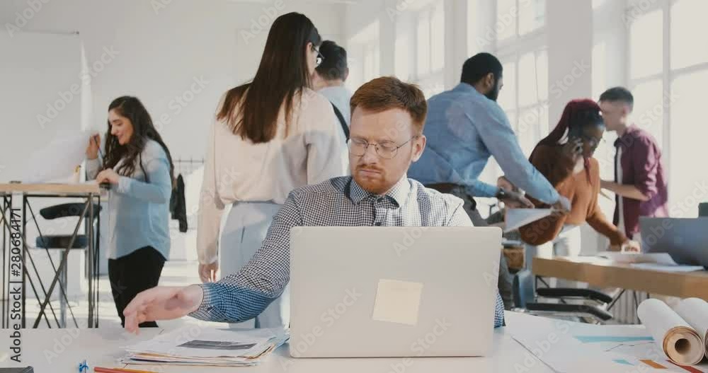 Tired stressed young corporate employee throws documents up, walks away ...