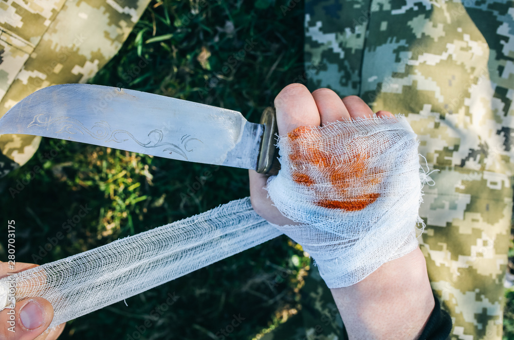 Man is putting bandage on bleeding wound. Injured hand. Cut with a ...