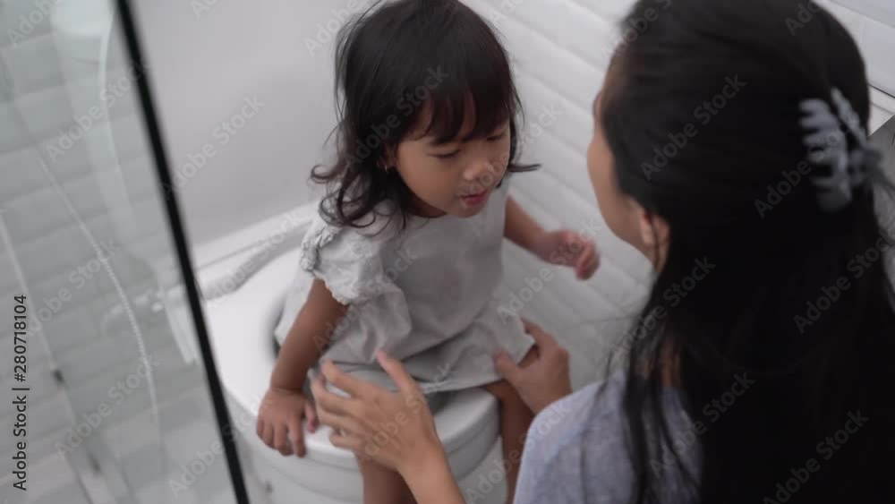 asian woman help her daughter to sit on the toilet while peeing Stock ビデオ | Adobe Stock