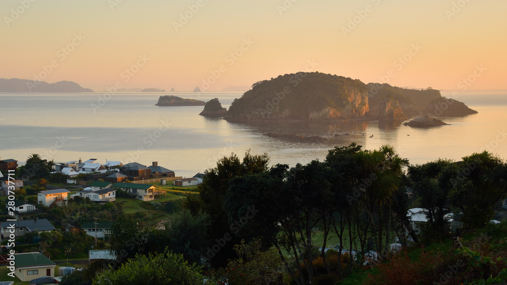 Hahei and a beautiful cliff lighted by the soft light of the sunset ...
