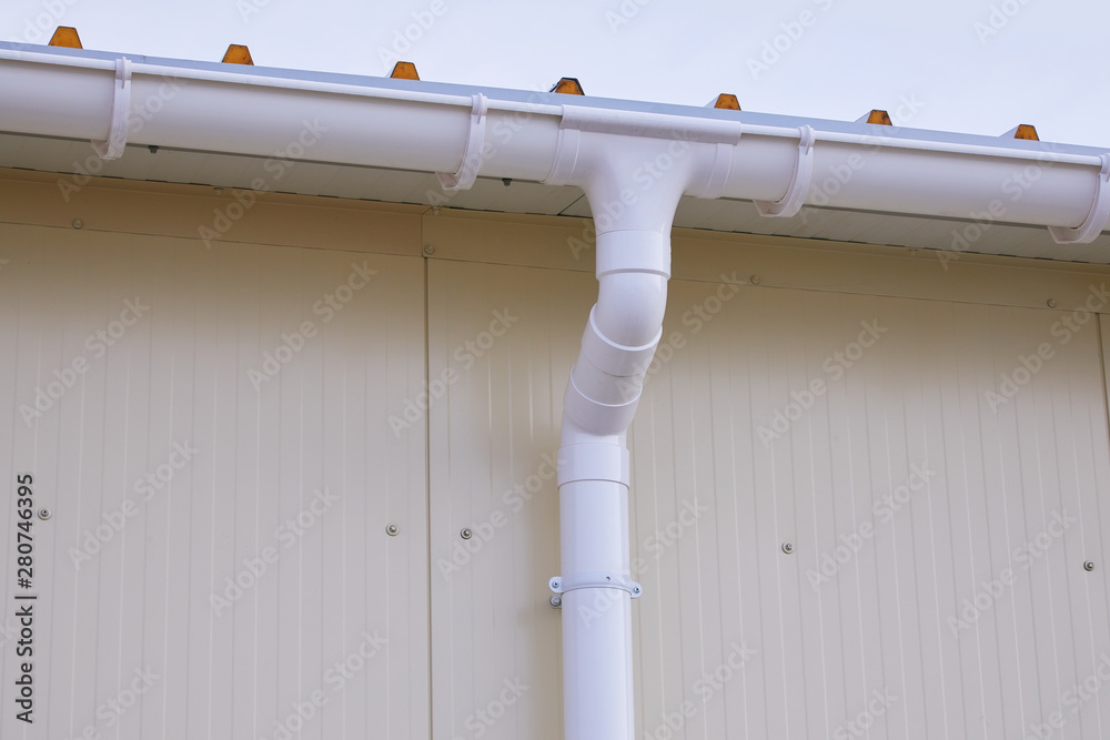 White plastic rain guttering system. Guttering drainage pipe exterior ...