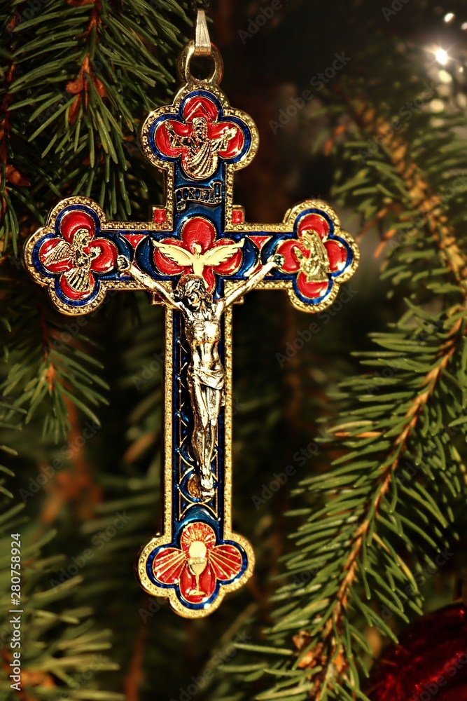 Crucifix depicting Holy Trinity on real Christmas tree. Concept that ...