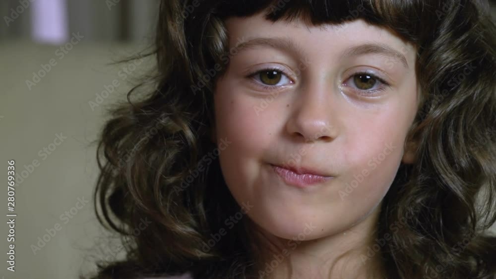 A close up portrait of a pretty female child while performing a nice ...
