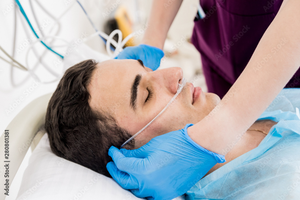 Doctors give resuscitation to a male patient in the emergency room ...