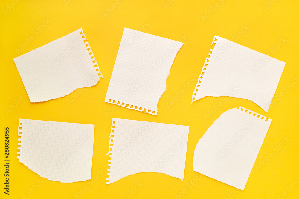 Yellow background and sheets of paper. Pieces of white paper are ...