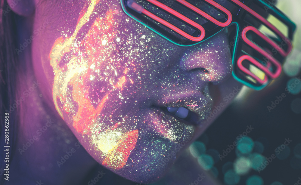 Beautiful young woman dancing and making party with fluorescent ...