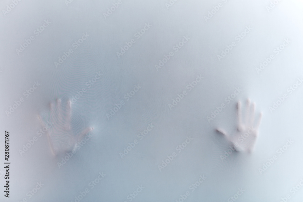 Shadow of hand. palms behind frosted glass representing dangerous, fear, help, horror and scary ...