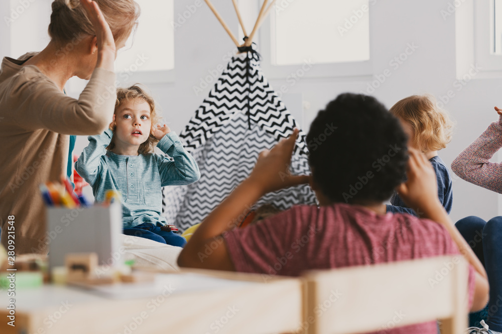 Kids and teacher playing together in preschool Stock Photo | Adobe Stock