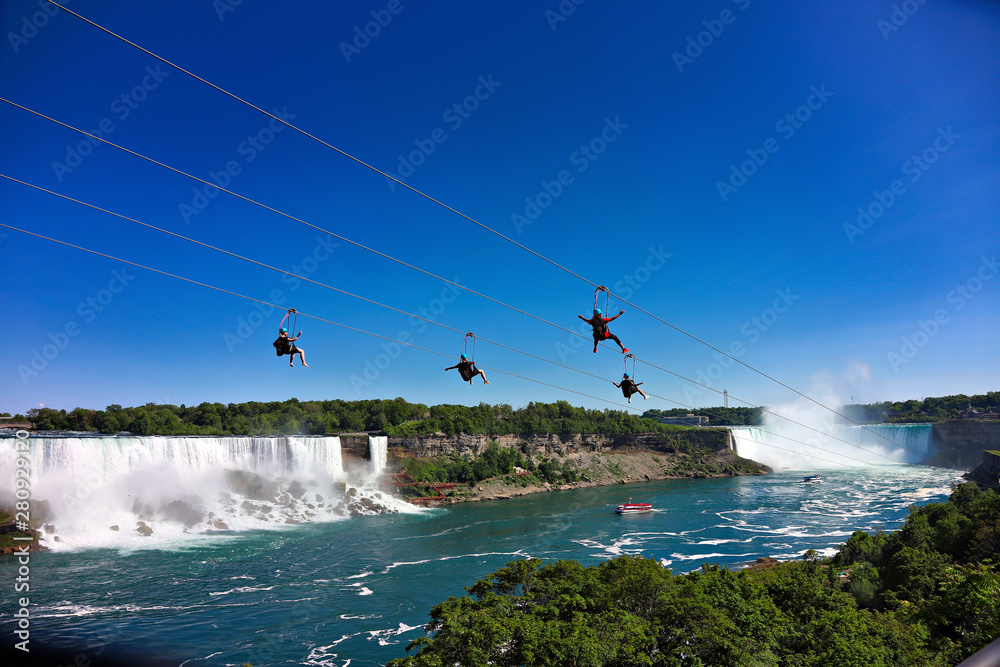 Tourists flying on zipline over Niagara Falls Stock Photo | Adobe Stock