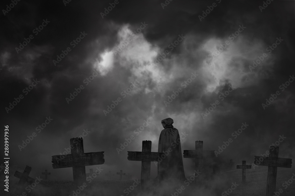 Scary background cemetery cross and the vampire in the hood stands back ...