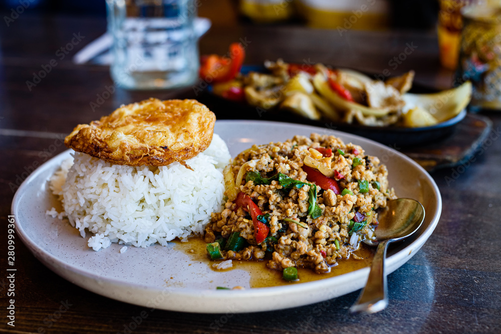 Thai basil chicken with rice and omelet. The authentic Thailand dish is ...