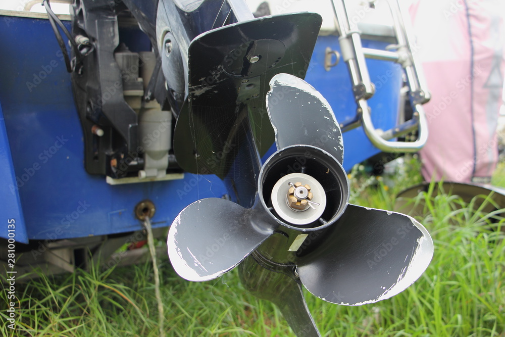 Close up lower unit of boat transom outboard motor - 3 blades propeller ...