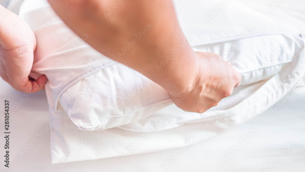 White pillow on the bed in the bedroom with woman 's hand who are ...