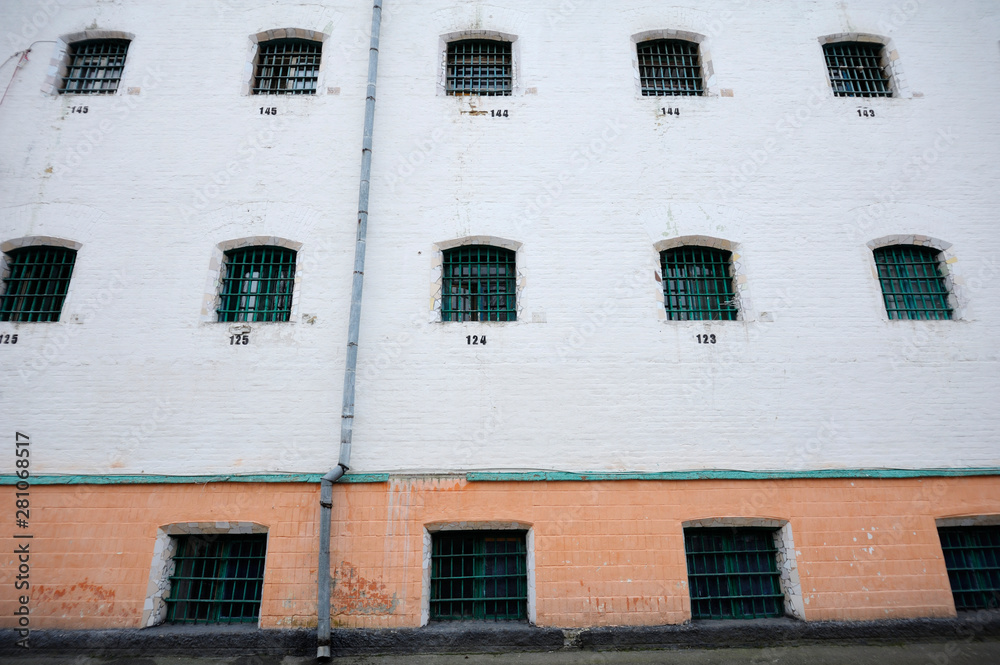Wall of a prison, windows with bars. Detention facility Stock Photo ...