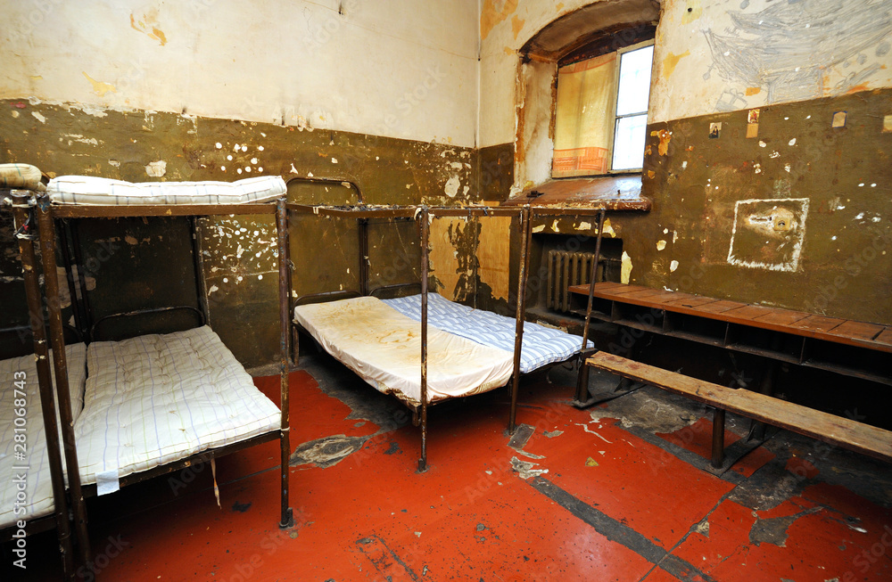 Ukrainian prison. Part of an old cell with bunks and mattresses, bars ...