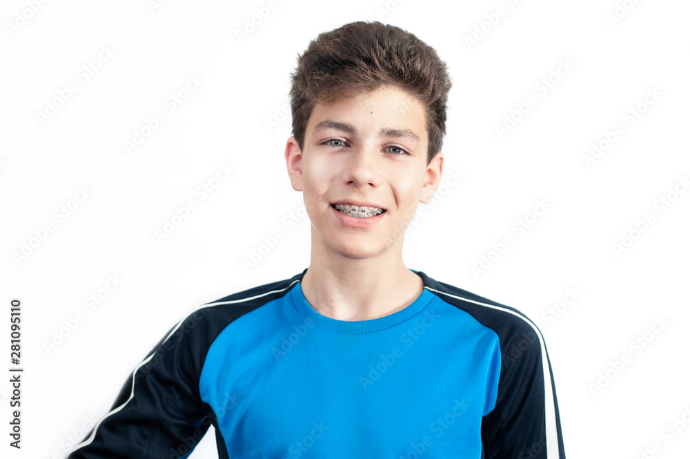Beautiful young boy smiles genuinely on a white background. Braces are ...