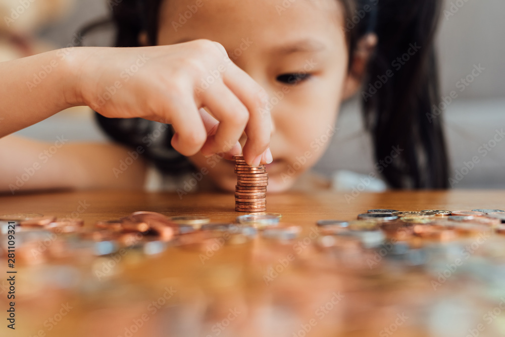 Little girl counting coins Stock Photo | Adobe Stock