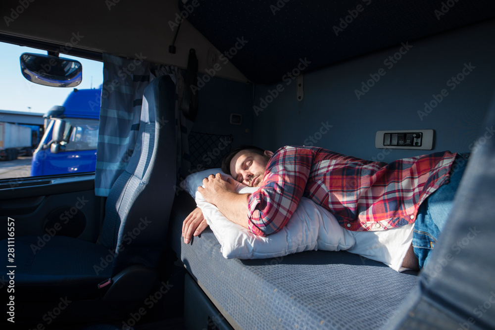 Truck driver sleeping in his cabin after working long routes overtime ...