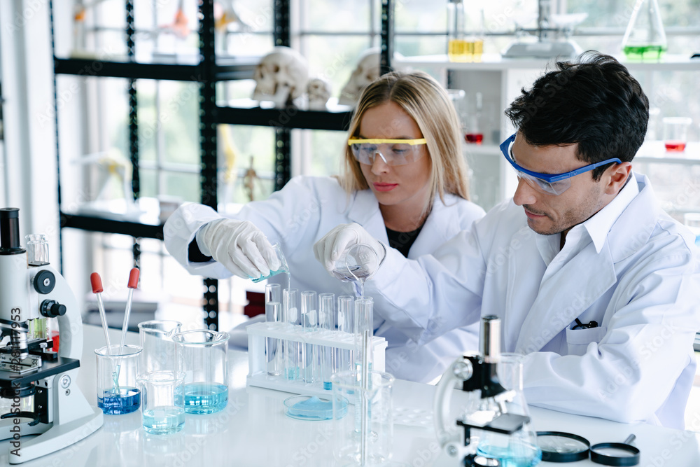 Scientists making testing with test tube while doing research in ...