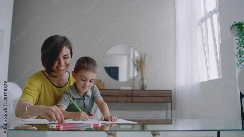 Beautiful young mother in a warm sweater lying on the floor with my son ...