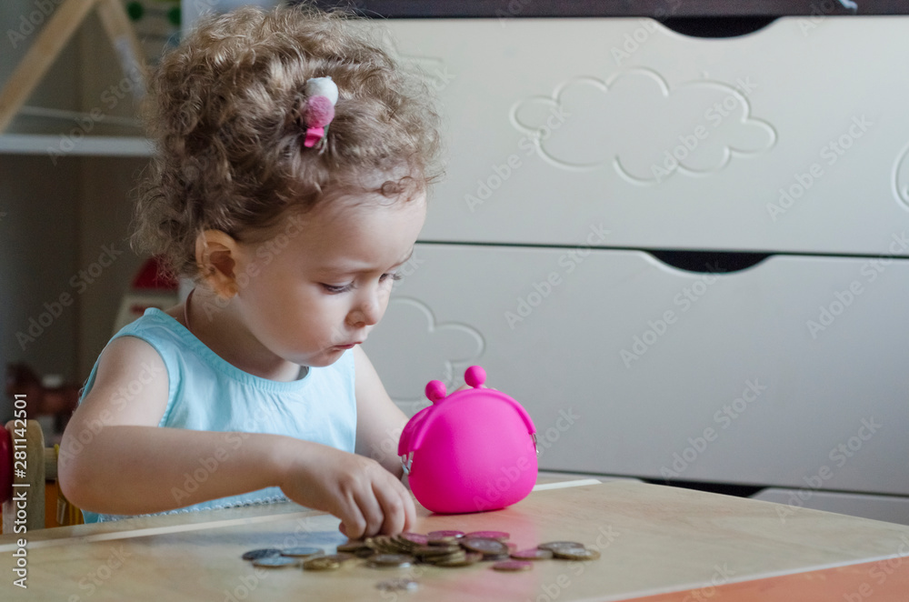 People, money, finances and savings concept. happy little girl putting ...