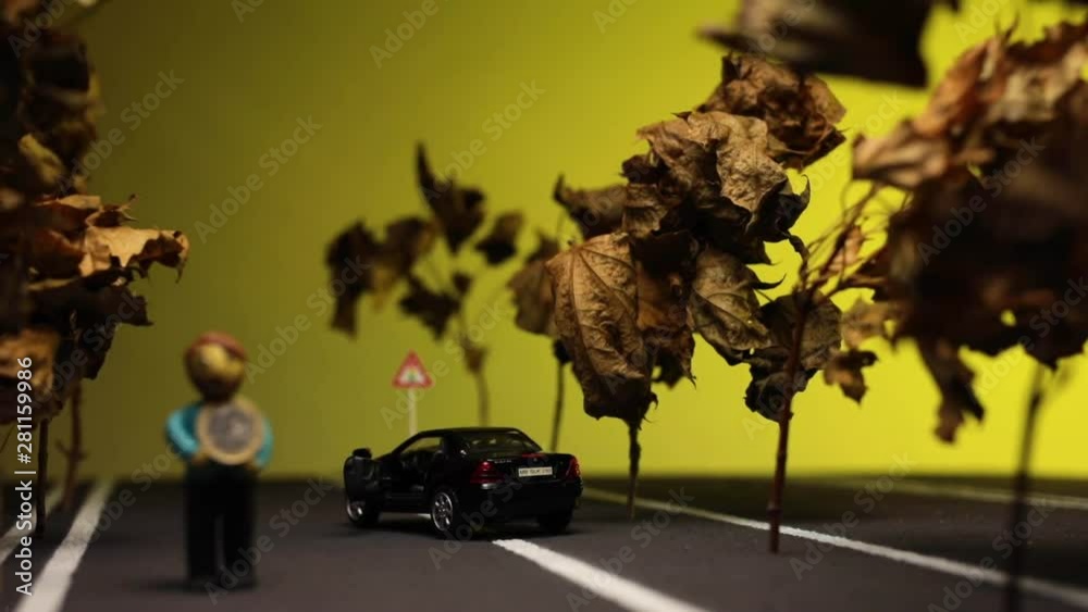 Video of a man sitting next to his broken, black, car figurine in the ...