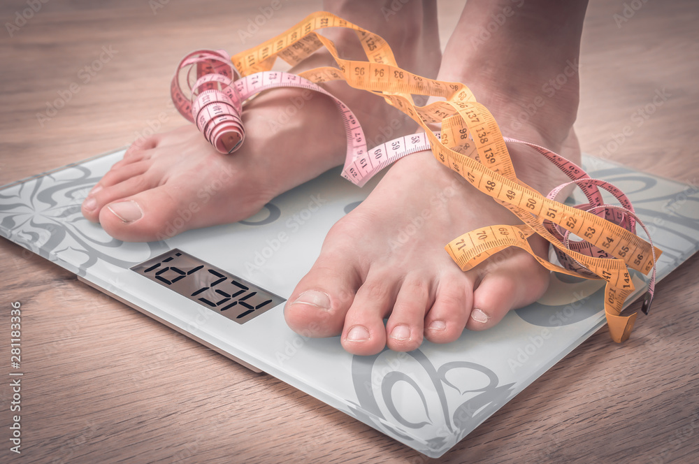 Female feet on personal scales with word HELP! Stock Photo | Adobe Stock