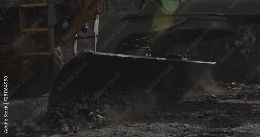 Slow motion close-up Motor Grader machine flattening and leveling ...