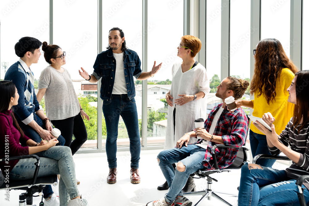 Attractive young multiethnic group talking at relax zone in coffee ...