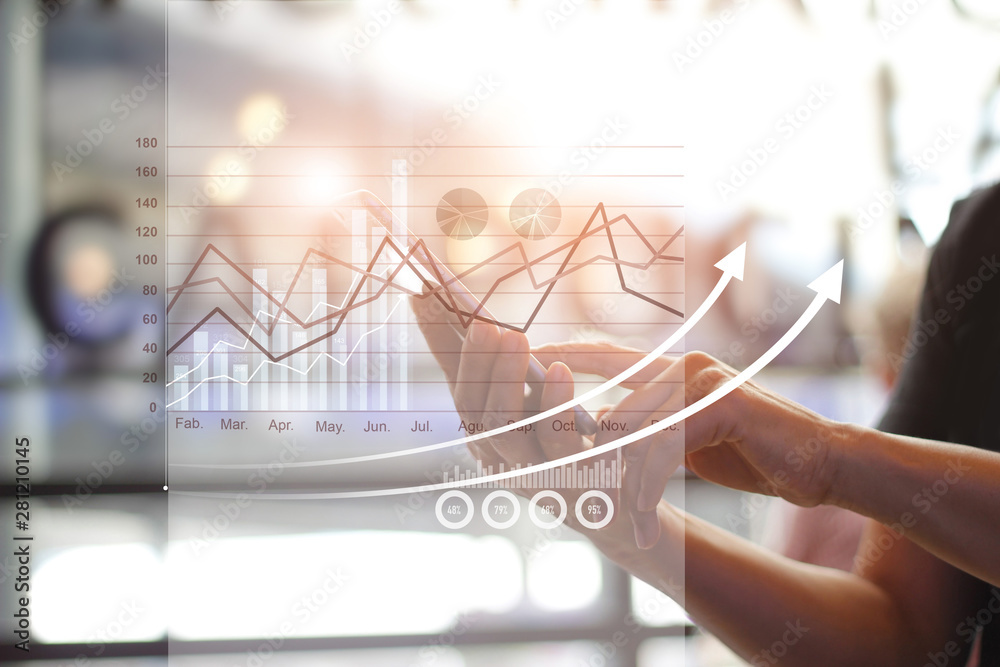Hands using mobile and analyzing sales data and economic growth graph ...