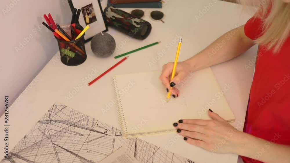 Close up girl draws a pencil on paper. Female fashion designer drawing ...