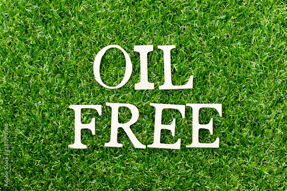 Wood alphabet letter in word oil freer on green grass background Stock ...