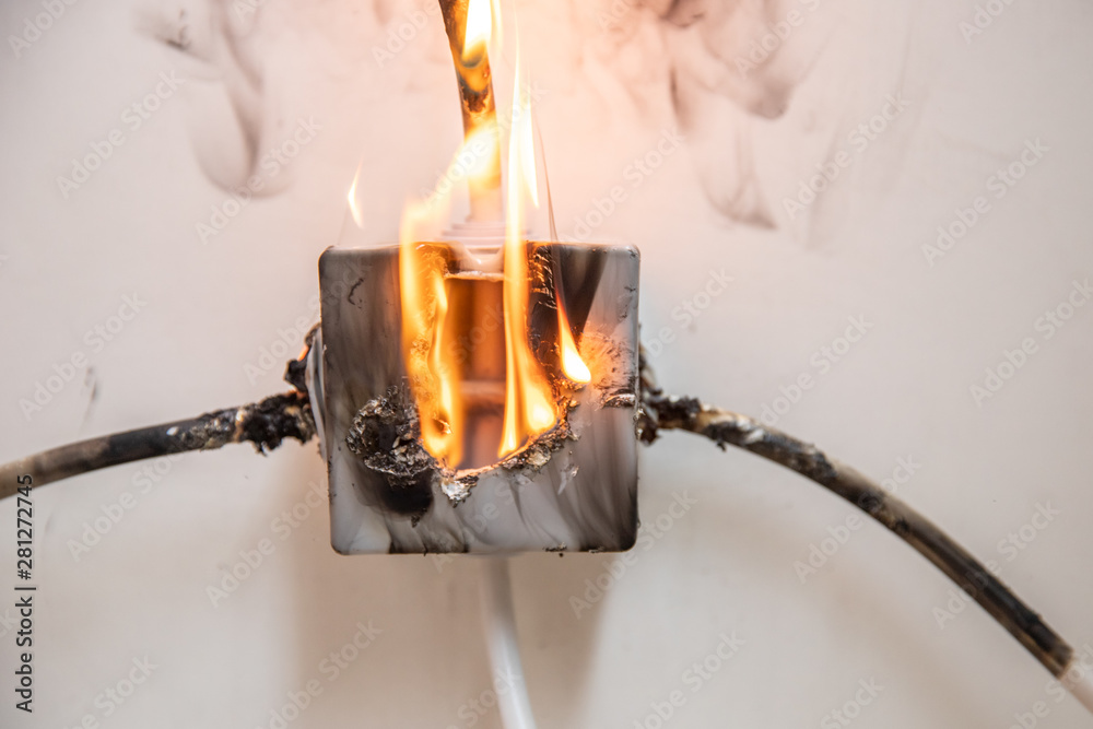 Electrical short circuit. Wiring cable on fire flame Stock Photo ...