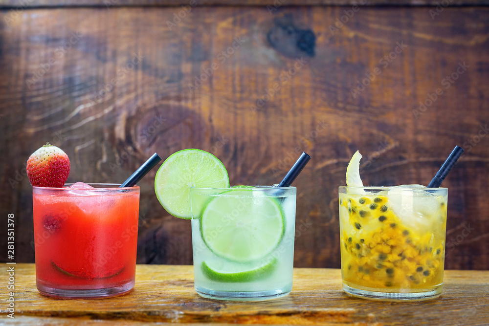 Traditional Brazilian alcoholic cocktail, lemon, strawberry and passion ...