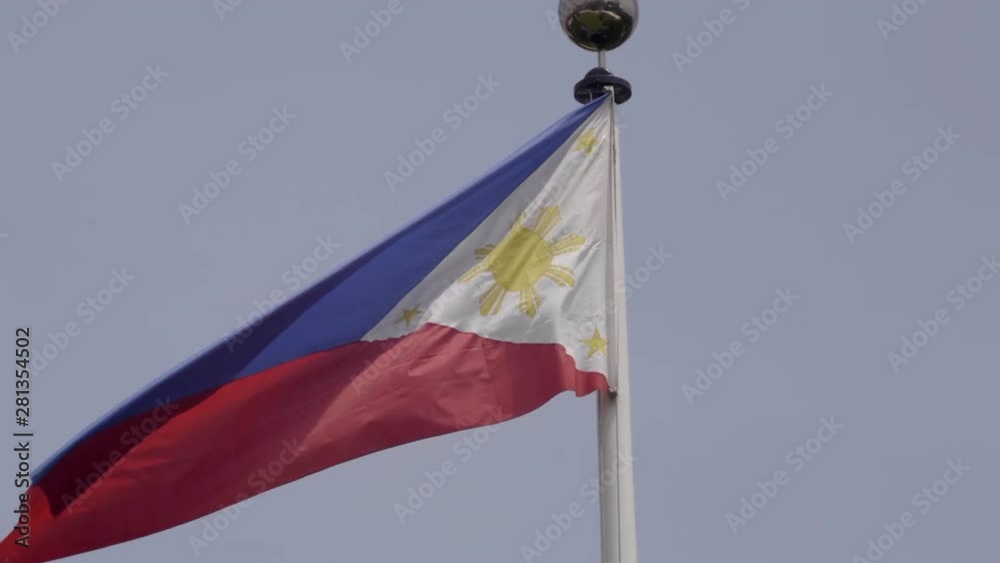 Philippines Flag Hanging At Flag Pole, Blue Sky Backdrop Stock Video | Adobe Stock