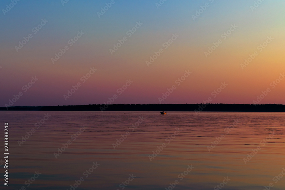 Sunset in the sea with a small fishing boat at the lake. A picture of a ...