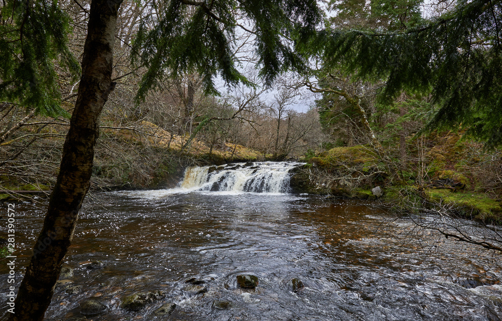 A small Waterfall with peat stained water tumbling over it into the ...