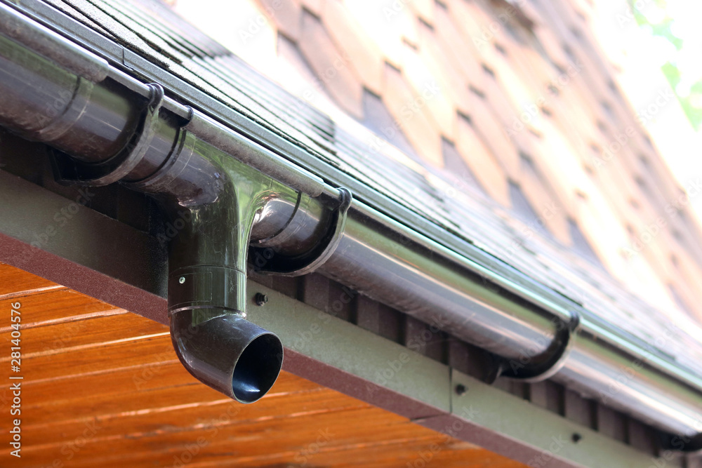 Modern roof of house with plastic rain gutter on beautiful natural ...