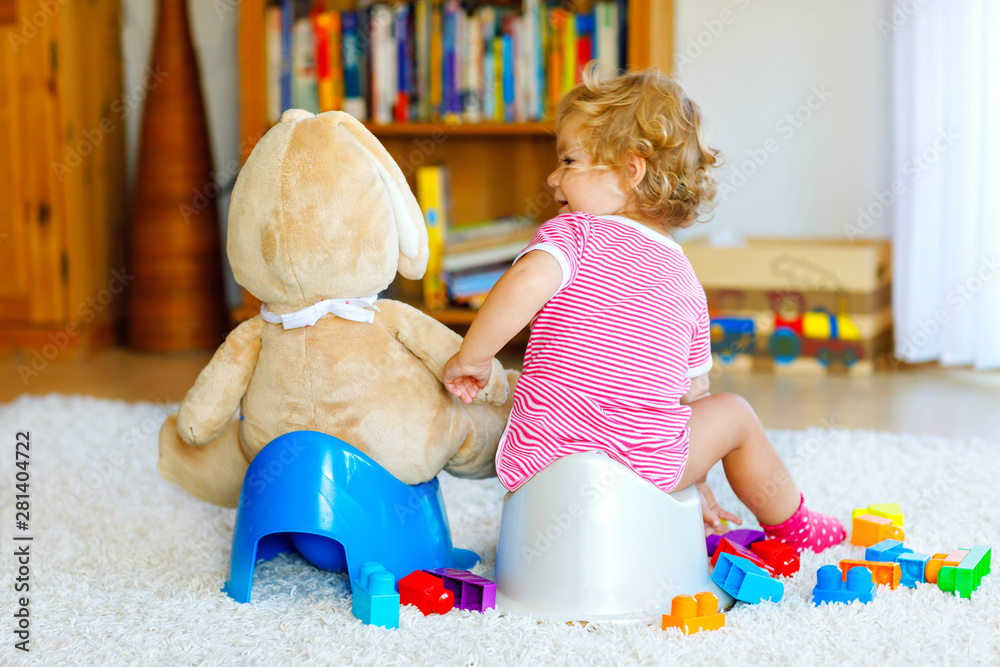 Closeup of cute little 12 months old toddler baby girl child sitting on ...