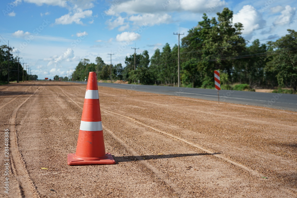 Red rubber cone is placed on the road during the construction of the ...