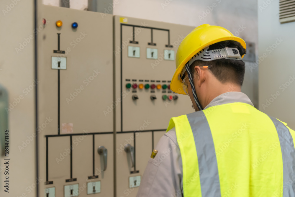 Asian electric engineer holding clipboard for checking and monitoring ...