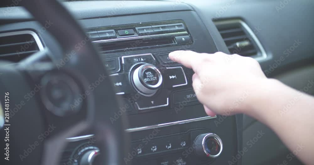 Pressing buttons and turning the volume dial on a car radio Stock Video ...